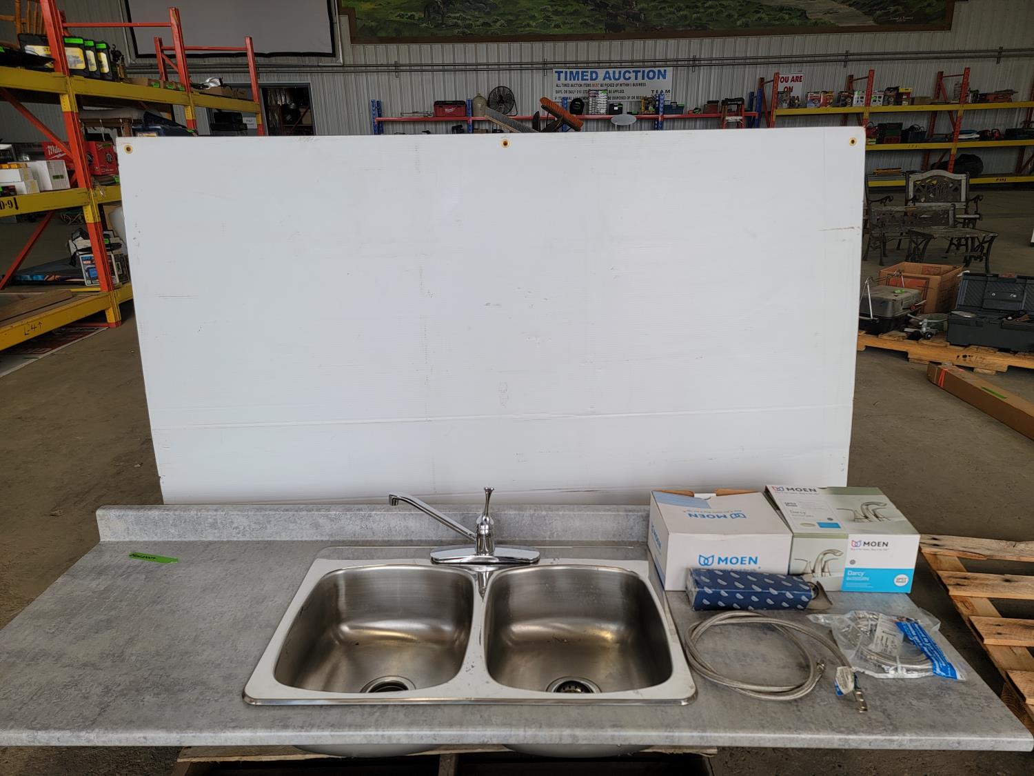 Counter with Stainless Steel Double Sink and Assorted Plumbing Hardware ...